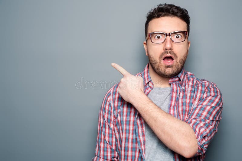 Man in Awe Pointing Away and Looking at Camera Stock Photo - Image of ...