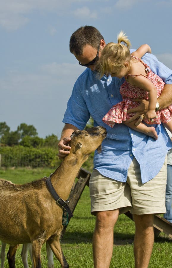 Man and baby with goat stock image. Image of care, animal - 9845741