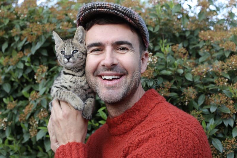 Man with baby serval cat stock photo. Image of animal - 215862228