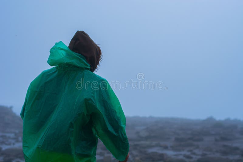 Man from the Back Wearing a Plastic Raining Suit and Looking from a ...