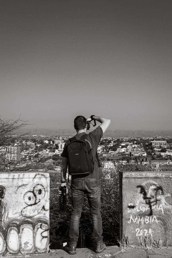 Man with a Backpack and Camera Photographing the Cityscape of Windhoek ...