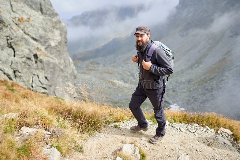 Man with backpack hiking stock photo. Image of climb - 158853714