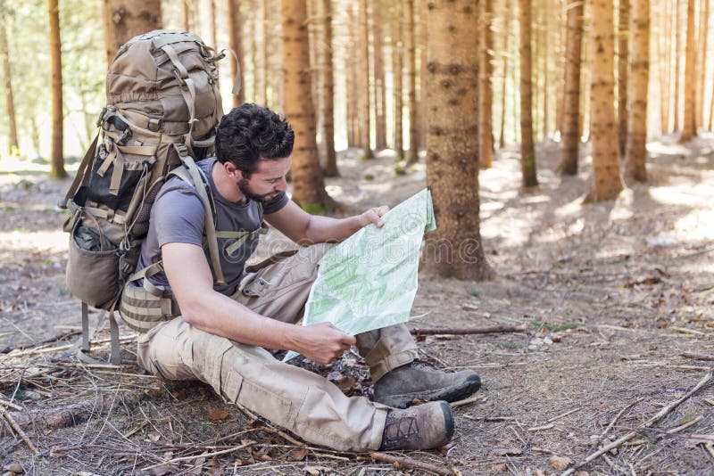 Man with Backpack and Map Searching Directions Stock Image - Image of ...