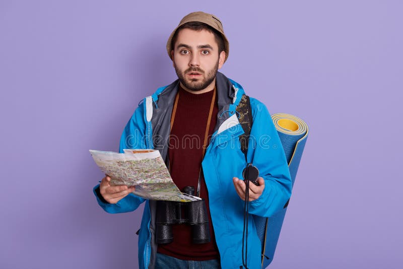 Man with Backpack and Map Searching Directions, Holding Compass in ...