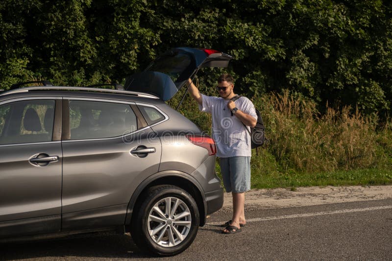 Man with Backpack at Open Car Trunk Stock Photo - Image of people ...
