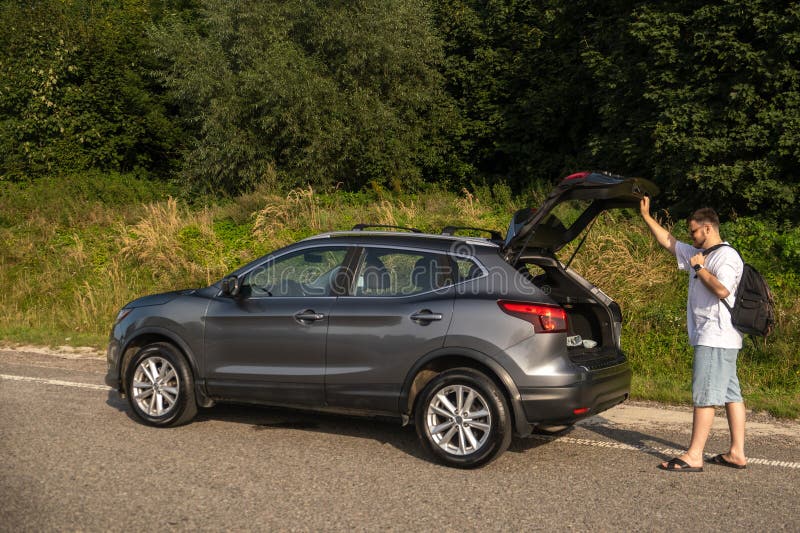 Man with Backpack at Open Car Trunk Stock Photo - Image of standing ...
