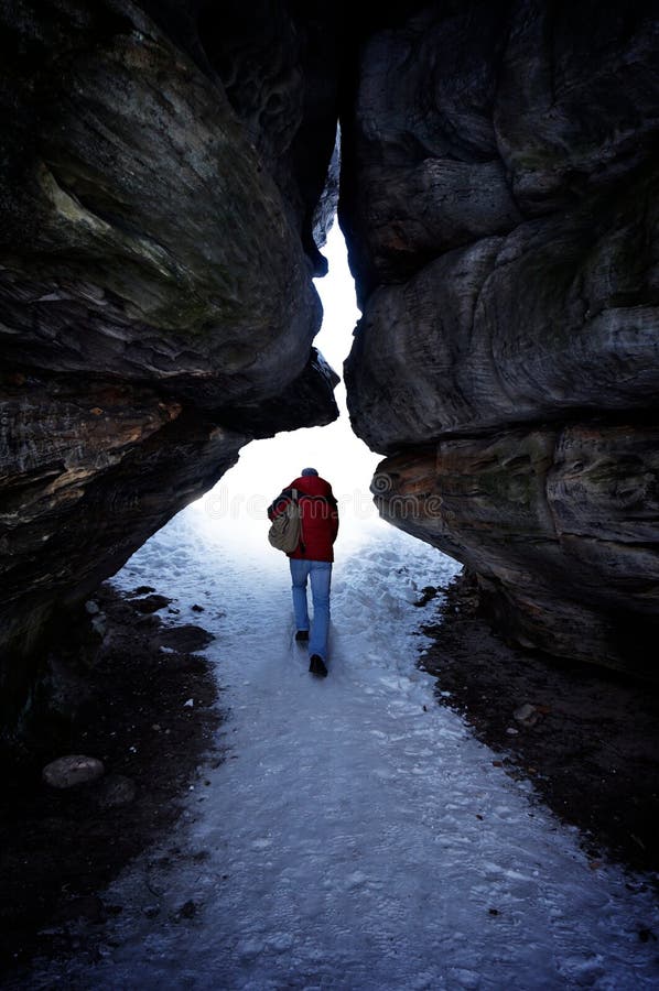 A Man with a Backpack Out of the Dark Snow-cavern in the Bright Light ...