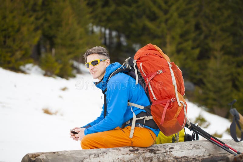 Man with backpack resting. stock photo. Image of male - 68604094