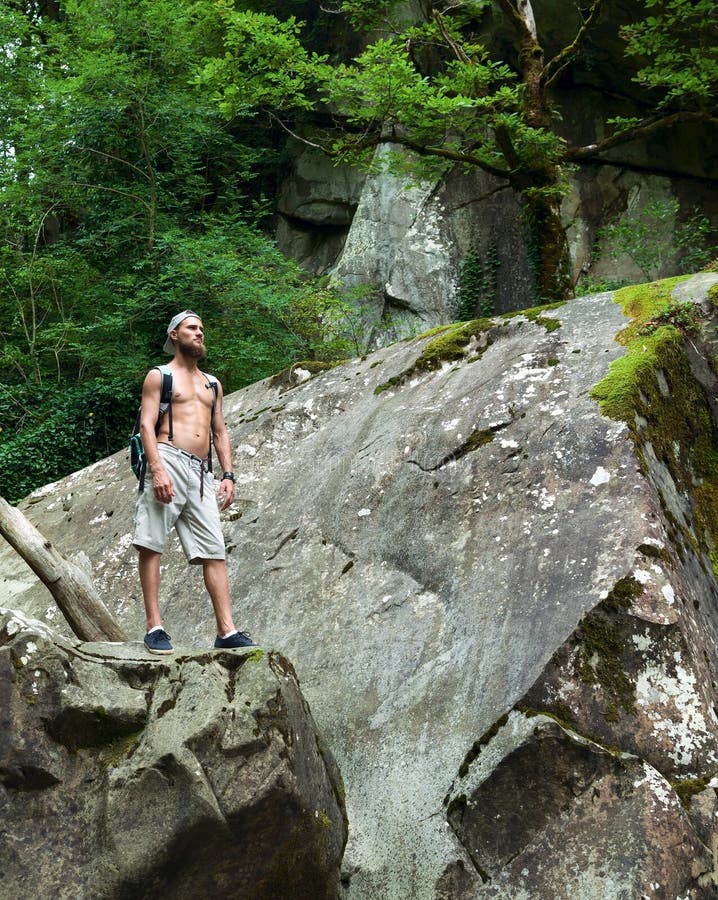 Man with backpack on rock stock image. Image of hike - 28441625