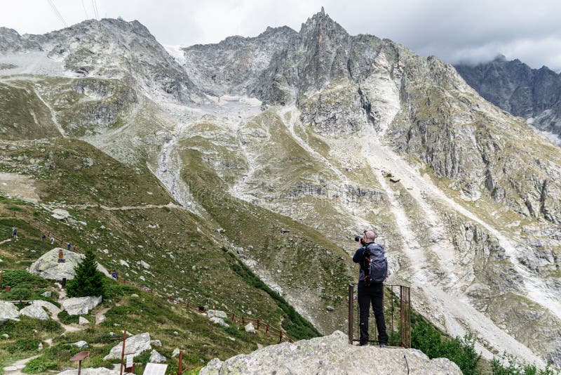 Man with a Backpack Standing on an Observation Deck and Photographing a ...