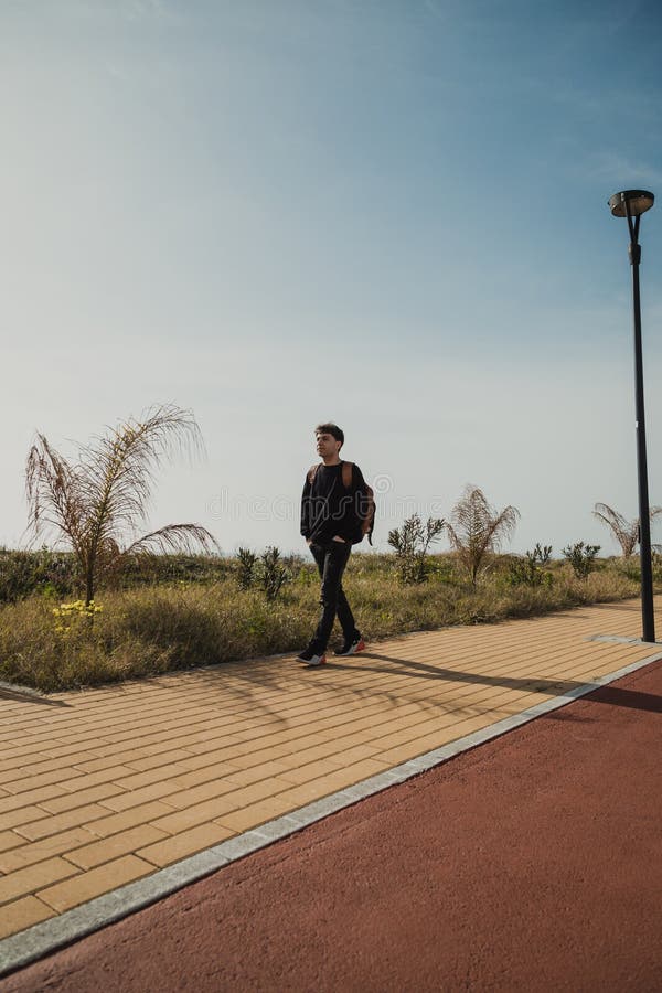 Man with Backpack Taking a Walk in the Nature Near the Grass Stock ...