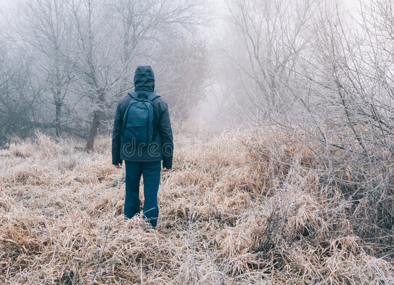 Man with Backpack Walking on Frost Grass with Tree in Fog. Czech Winter ...