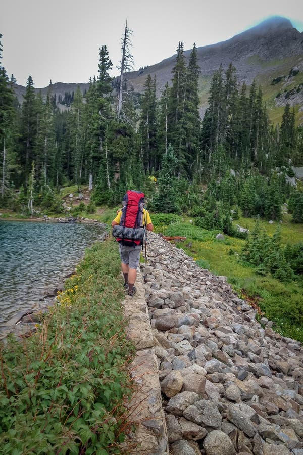 Man Backpacking in the Mountains with a Red Backpack Stock Photo ...