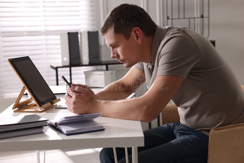 Man with Bad Posture Using Smartphone in Office Stock Photo - Image of ...