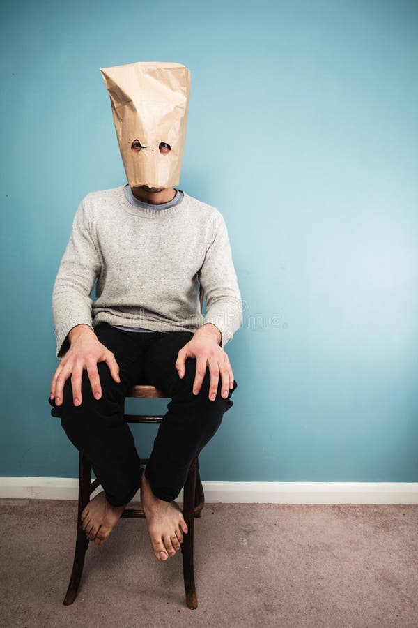 Man with Bag Over Head on Chair Stock Image - Image of spooky, weird ...