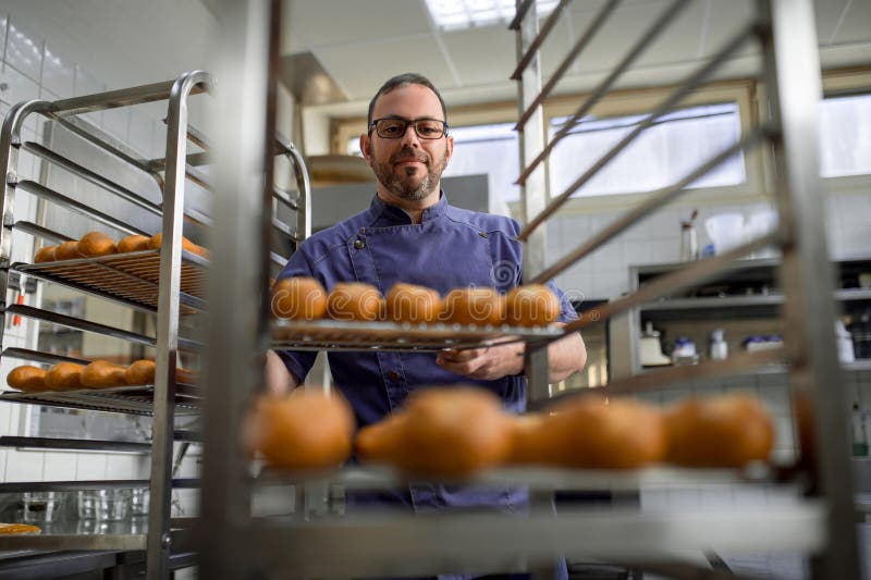 Man Baker with Trays of Fresh Bread in Bakery. Stock Image - Image of ...