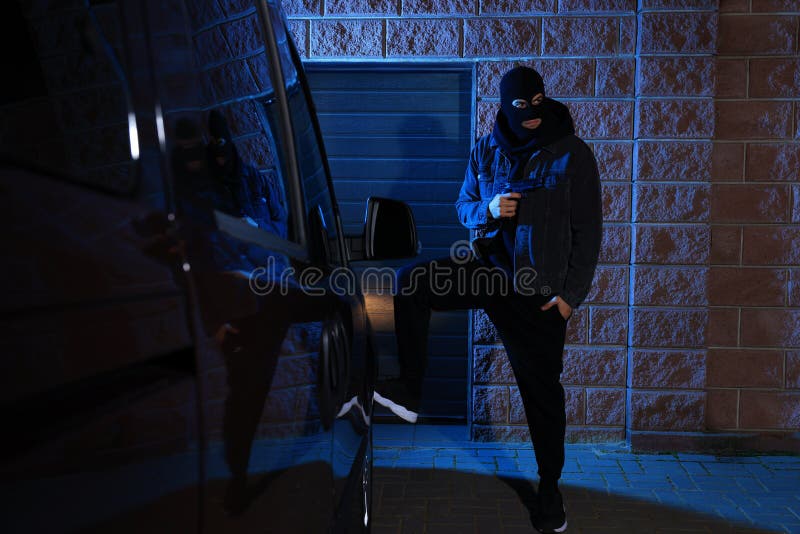 Man in Balaclava with Gun Near Van Outdoors Stock Photo - Image of ...