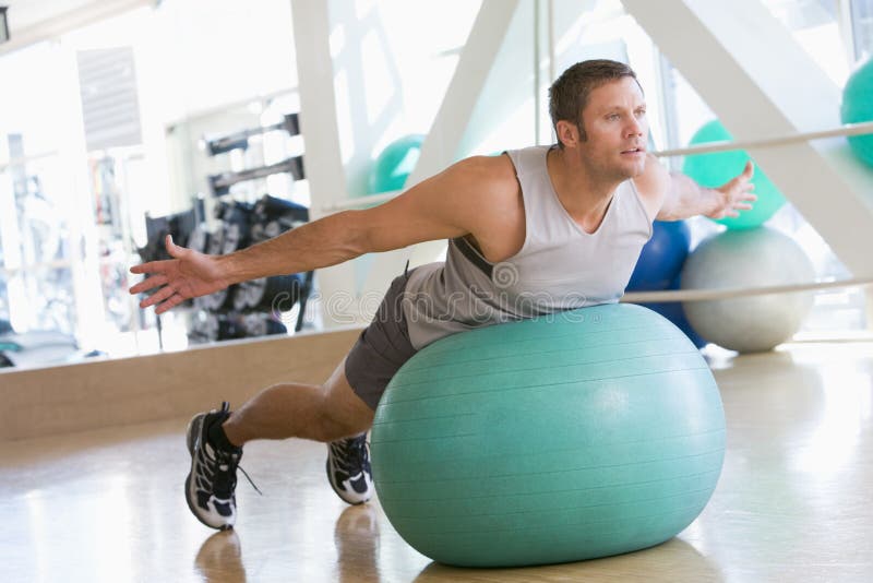 Man Balancing on Swiss Ball at Gym Stock Image - Image of muscular ...