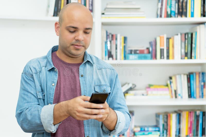 Man with Bald Reading a Message at Mobile Phone Stock Image - Image of ...