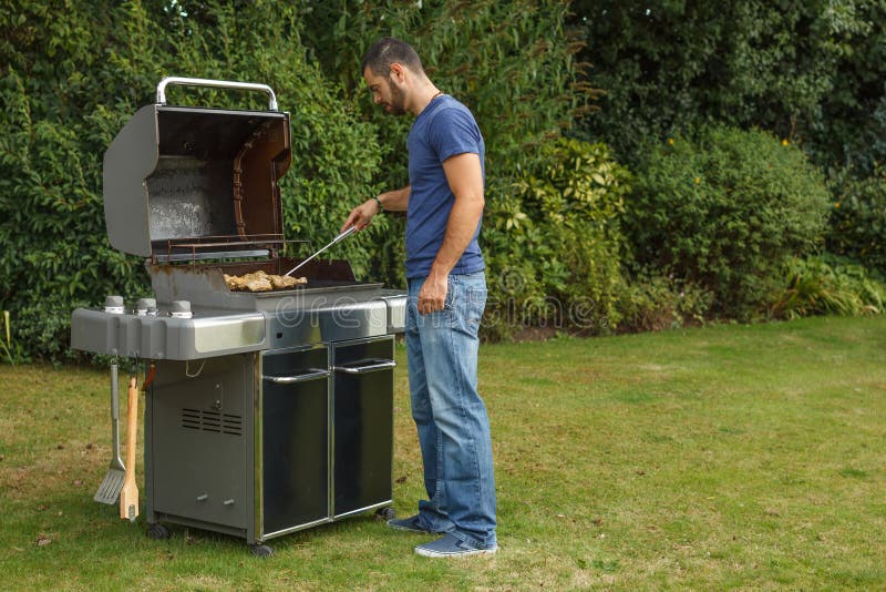 Man at a barbecue grill stock photo. Image of party, male - 43831984