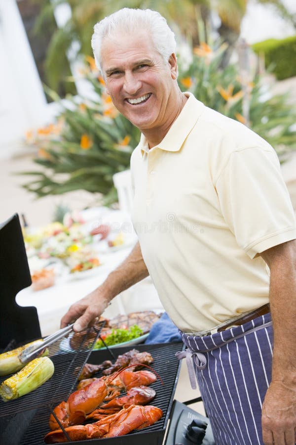 Man Barbequing in a Garden stock photo. Image of outdoors - 7230618