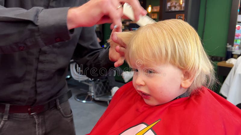 Behind Shoulder View of Male Barber Cutting Little Boy S Hair. Stock ... Behind Shoulder View of Male Barber Cutting Little Boy S Hair. Stock ...