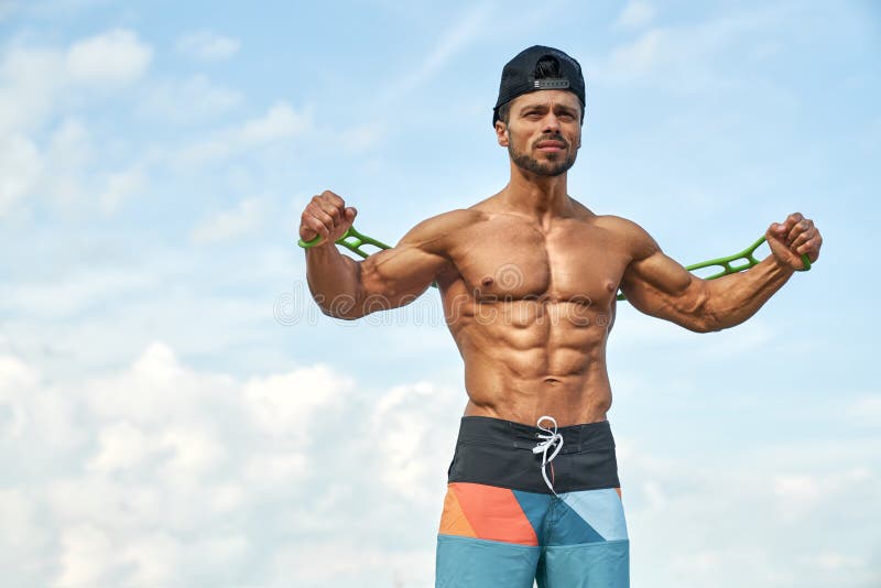 Man with Bare Chest Pulling Silicons Expander by Hands. Stock Image ...