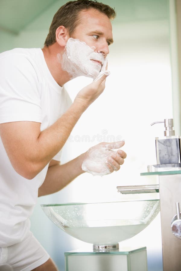 Man in bathroom shaving stock image. Image of grooming - 5930589