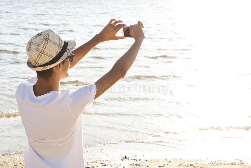 Man on the Beach with the Camera Phone Stock Image - Image of camera ...