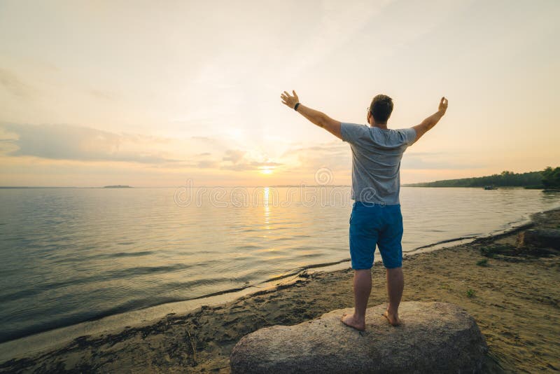 Man on the Beach Looking on Sunrise with Hands Up Stock Photo - Image ...