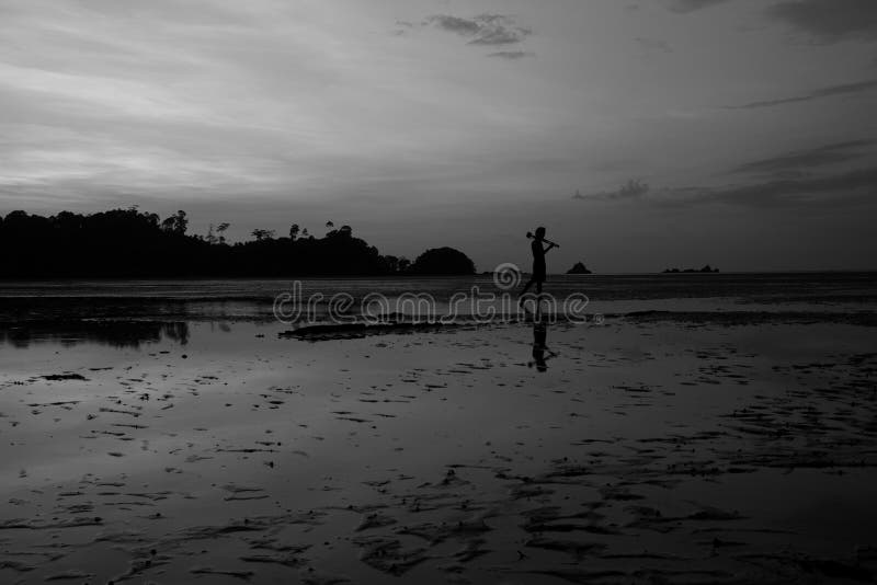 Man on the Beach with Reflection in Water during Sunset. Stock Photo ...