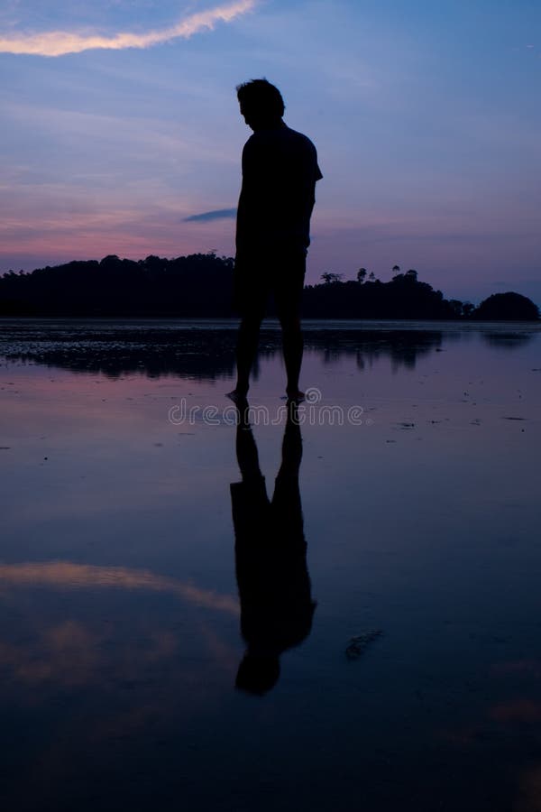 Man on the Beach with Reflection in Water during Sunset. Stock Photo ...