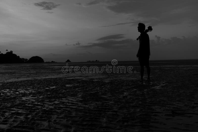 Man on the Beach with Reflection in Water during Sunset. Stock Image ...