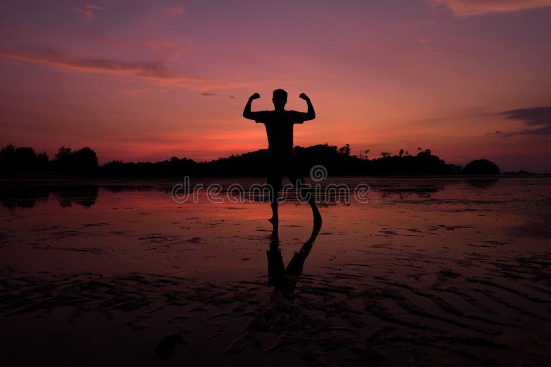 Man on the Beach with Reflection in Water during Sunset. Stock Photo ...