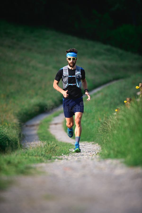 Man with Beard Athlete Running in the Mountains during a Workout Stock ...