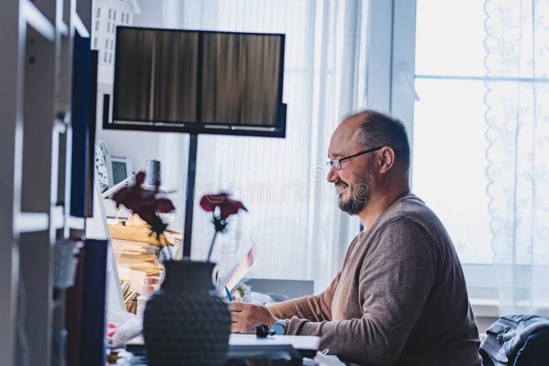 Man with a Beard and Glasses is Sitting in His Office Stock Image ...