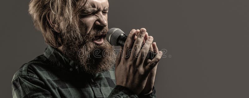 Man with a Beard Holding a Microphone and Singing. Bearded Man in ...