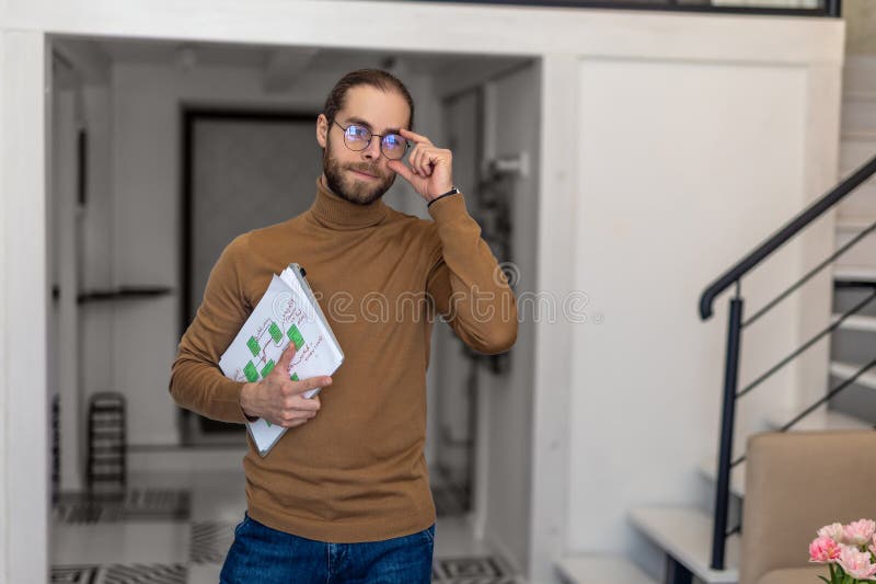 Man with Beard Standing Holding Paper Graph in Home Interior. Stock ...