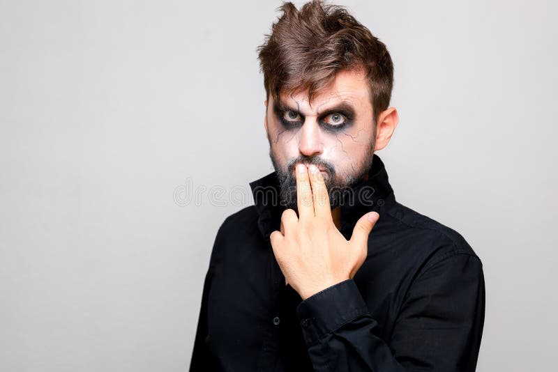 Man with a Beard and Undead Makeup on Halloween Holds His Hands in ...