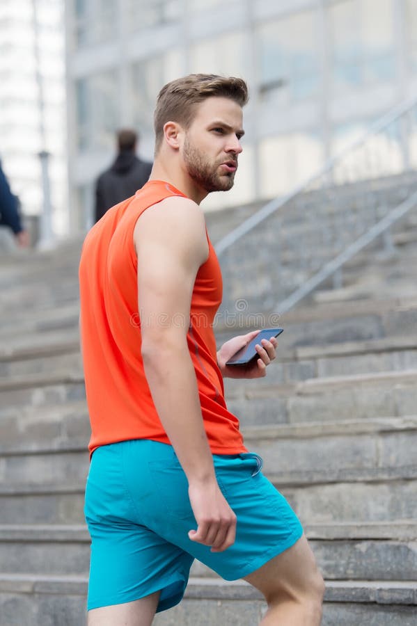 Man With Beard Walks With Smartphone Urban Background With Stairs Man