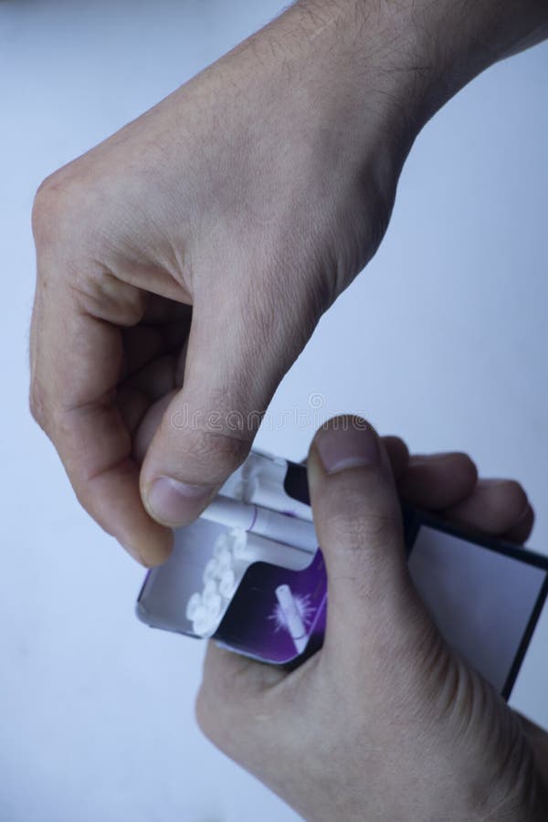A Man Beats a Cigarette. the Beginning of Smoking. Cigarette in the ...