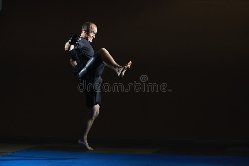 Strong Man Beats with a Kick Leg Stock Image - Image of black, defense ...
