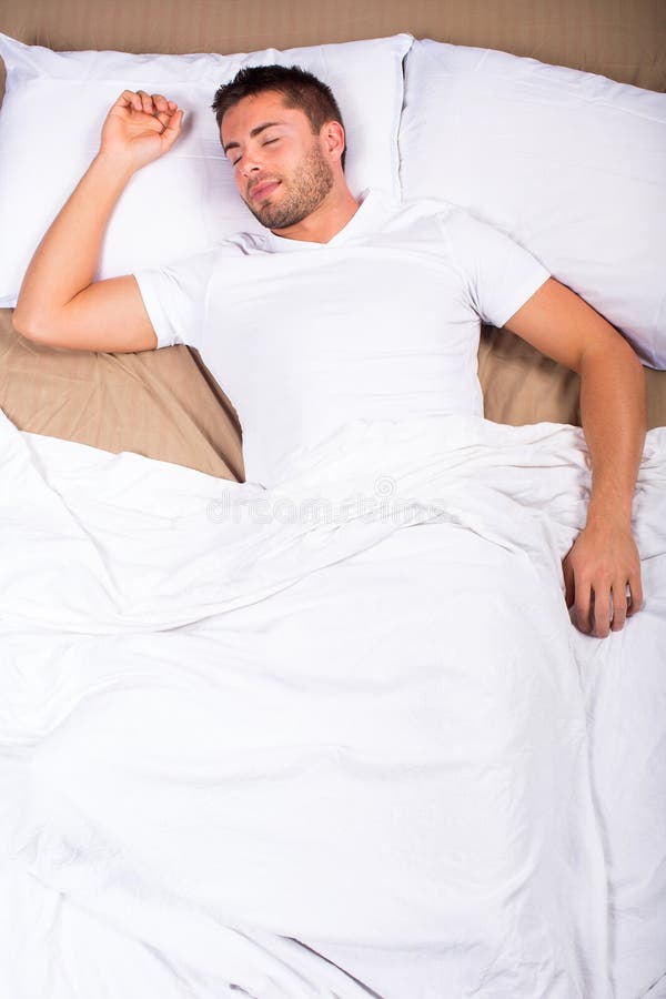 Sleeping man into bed stock photo. Image of wall, young - 35797234
