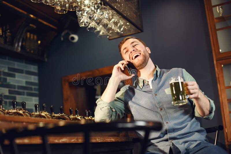 Man with Beer at Bar with a Phone Stock Photo - Image of cheerful ...