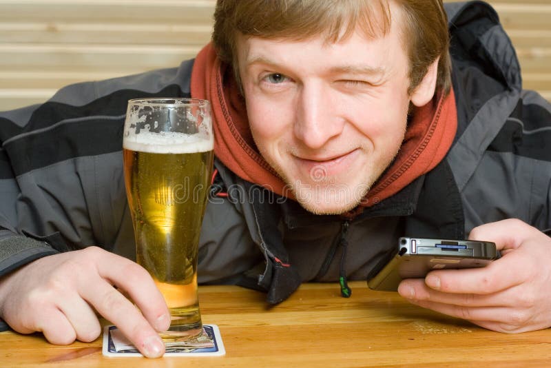 Man with Beer and Palm-size Computer Stock Image - Image of wink, facer ...