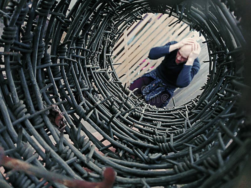 The Man Behind the Barbed Wire is in Despair. Focus on the Wire Stock ...