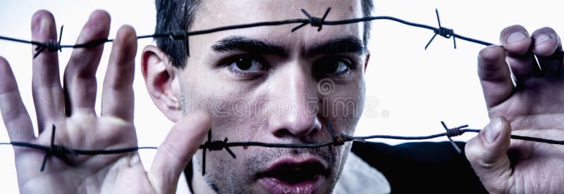 Man Behind a Barbed Wire As Symbol of Pain and Despair. Selective Focus ...