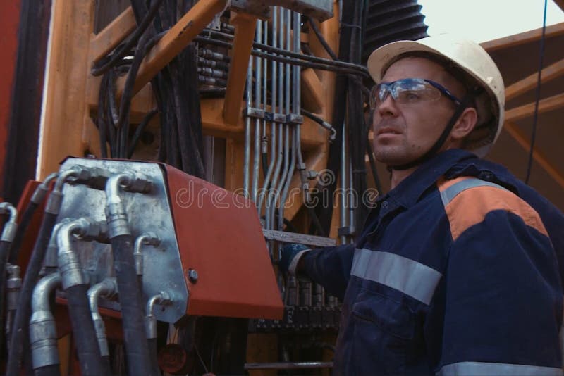 The Man Behind the Control Panel. Levers for Controlling Hydraul ...