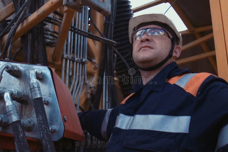 The Man Behind the Control Panel. Levers for Controlling Hydraul ...