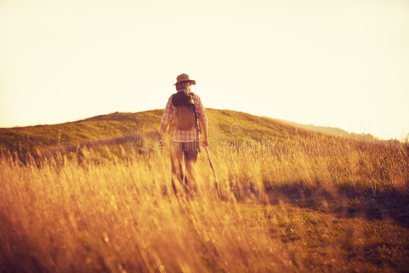 Man from Behind Walking on Hill in the Sunset Stock Photo - Image of ...